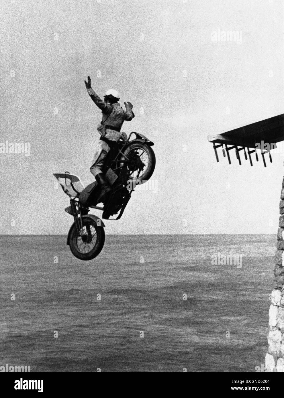 French Stunt Man Patrick Bernard rides a motorcycle off a cliff into ...