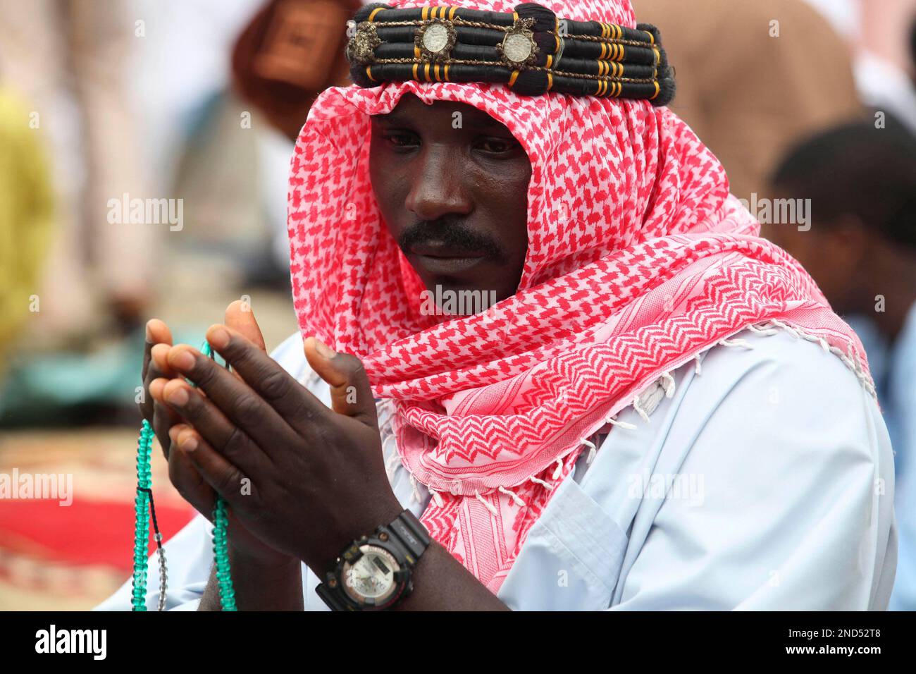 A Nigerian Muslim prays during Eid al-Fitr morning prayer, which marks ...