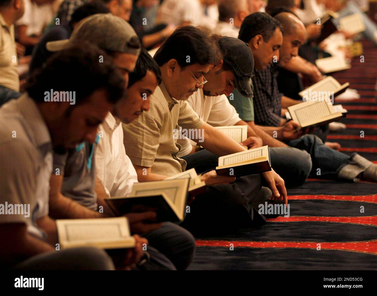 Lebanese Muslims read verses of the Quran, the Muslims holy book before ...