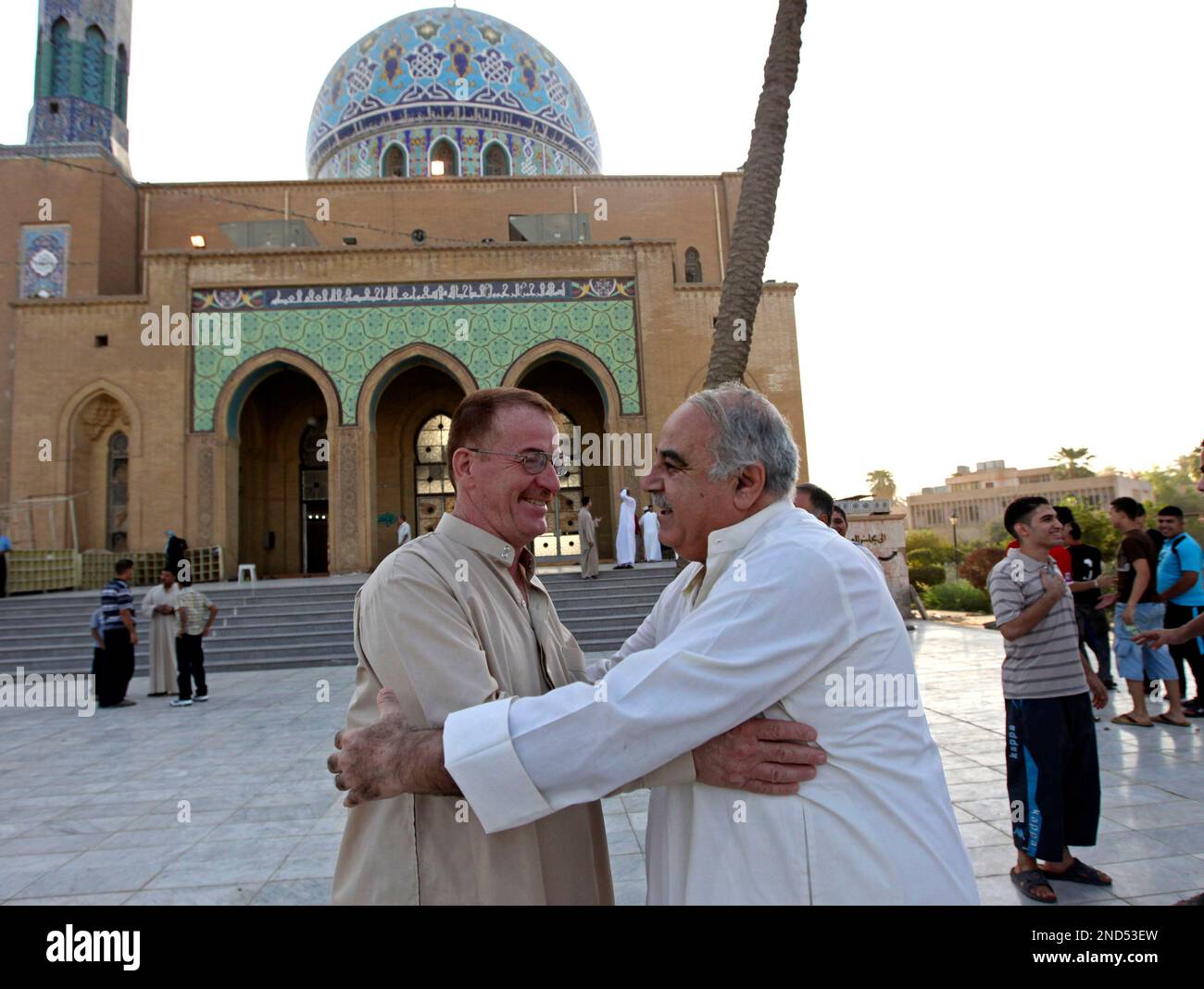 Iraqi Sunni Muslims exchange greetings after Eid prayers outside the ...