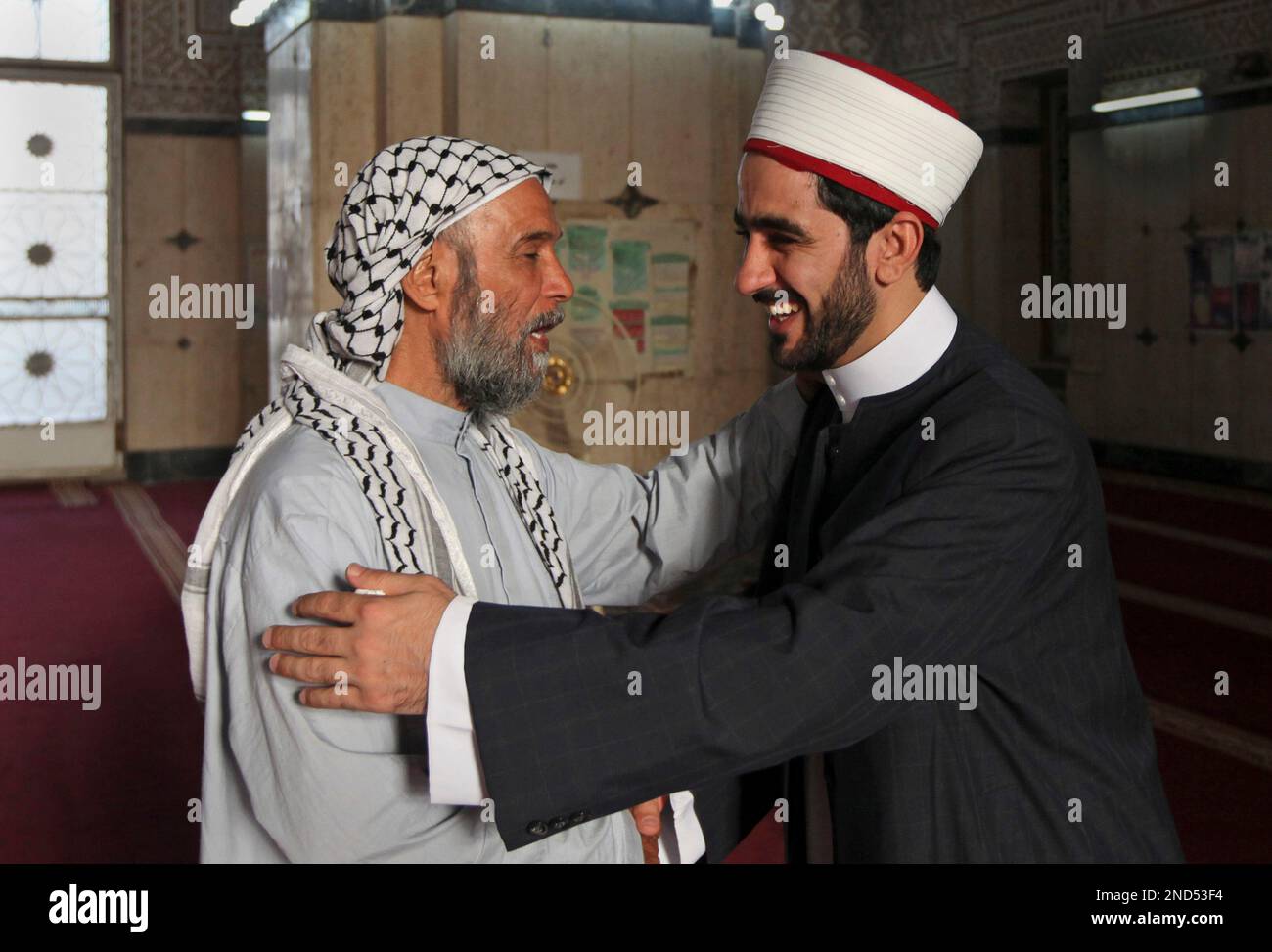 Iraqi Sunni Muslims exchange greetings after Eid prayers in the 14th ...