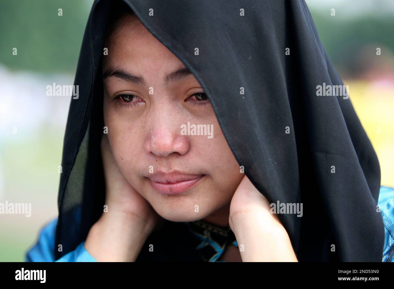 A Filipino Muslim woman cries as she attends a prayer at Manila's Rizal ...