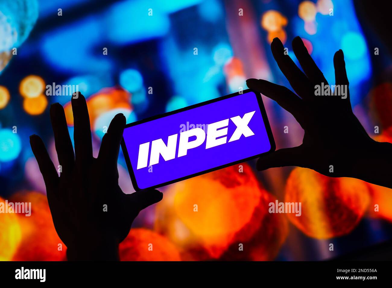 In this photo illustration, the INPEX Corporation logo is seen displayed on a smartphone Stock ...