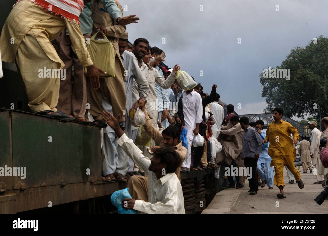 People travel on an overcrowded train to reach their homes to celebrate ...