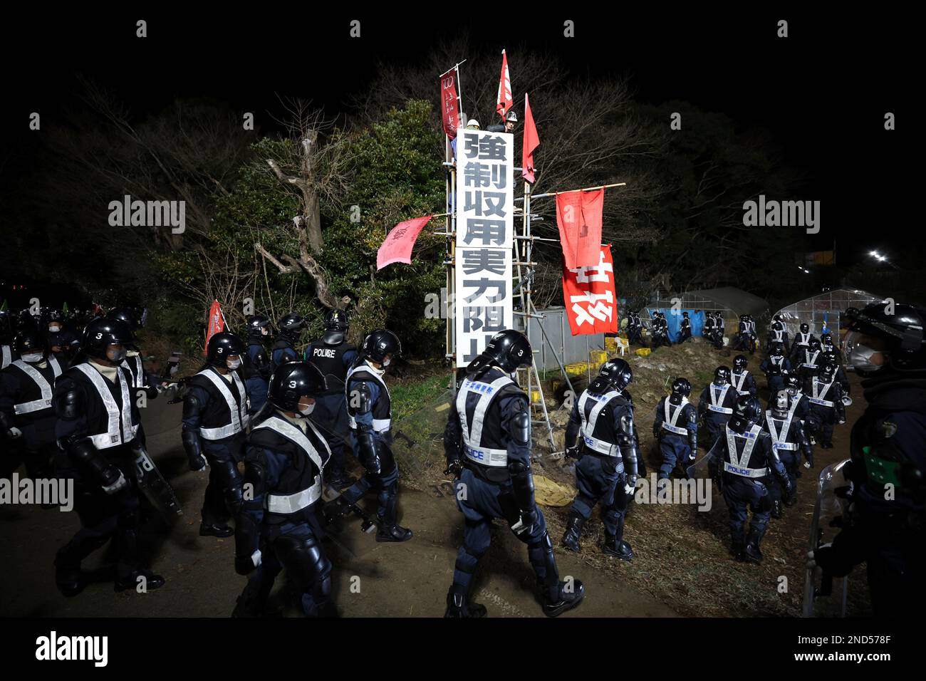 Riot police officers starts a compulsory execution at Narita ...