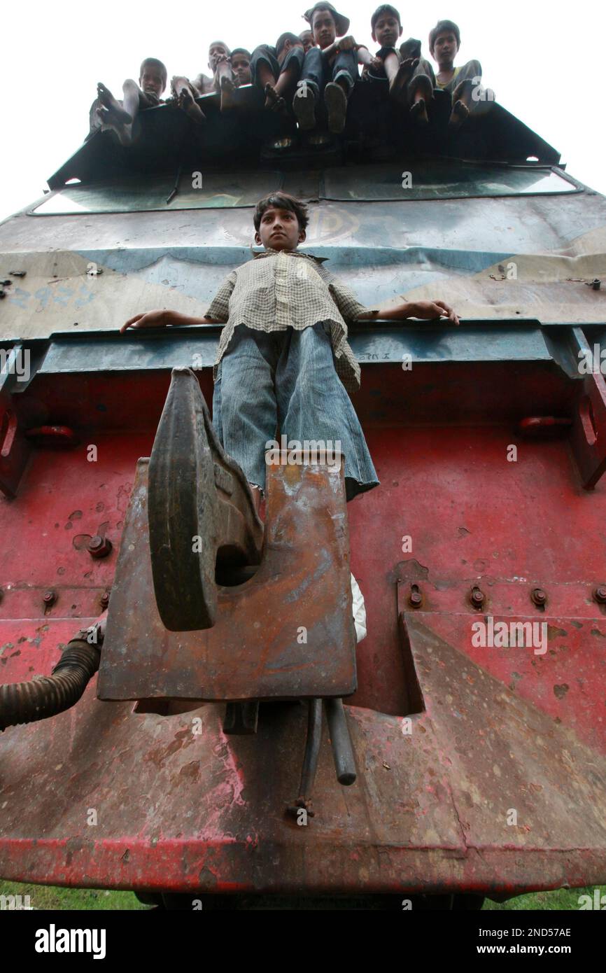 Bangladeshi children sit atop the locomotive engine of a crowded ...
