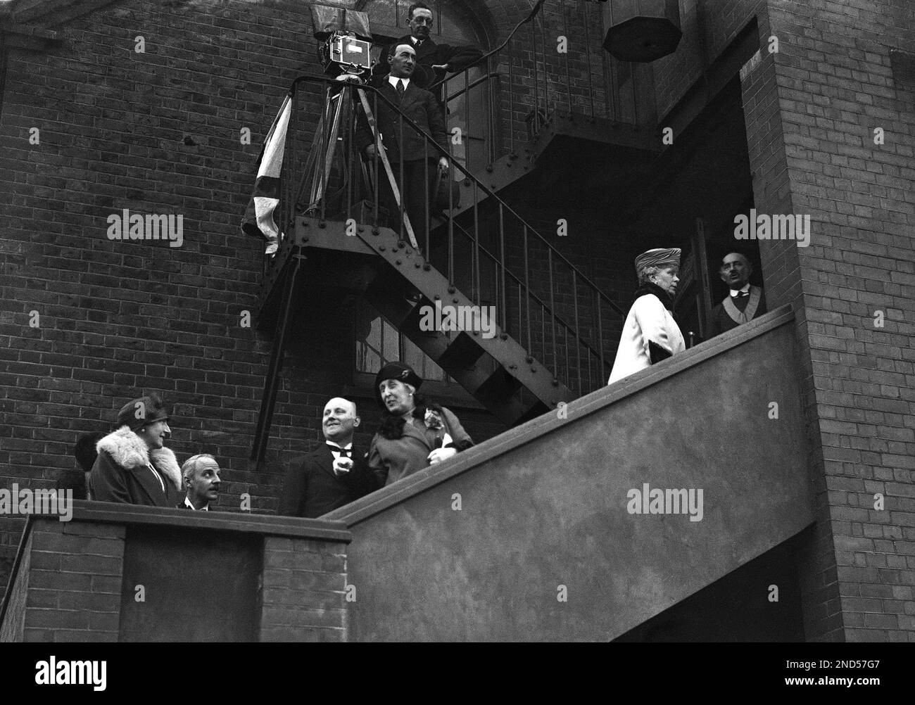 Britain's Queen Mary walking up steps followed by Princess Helena ...
