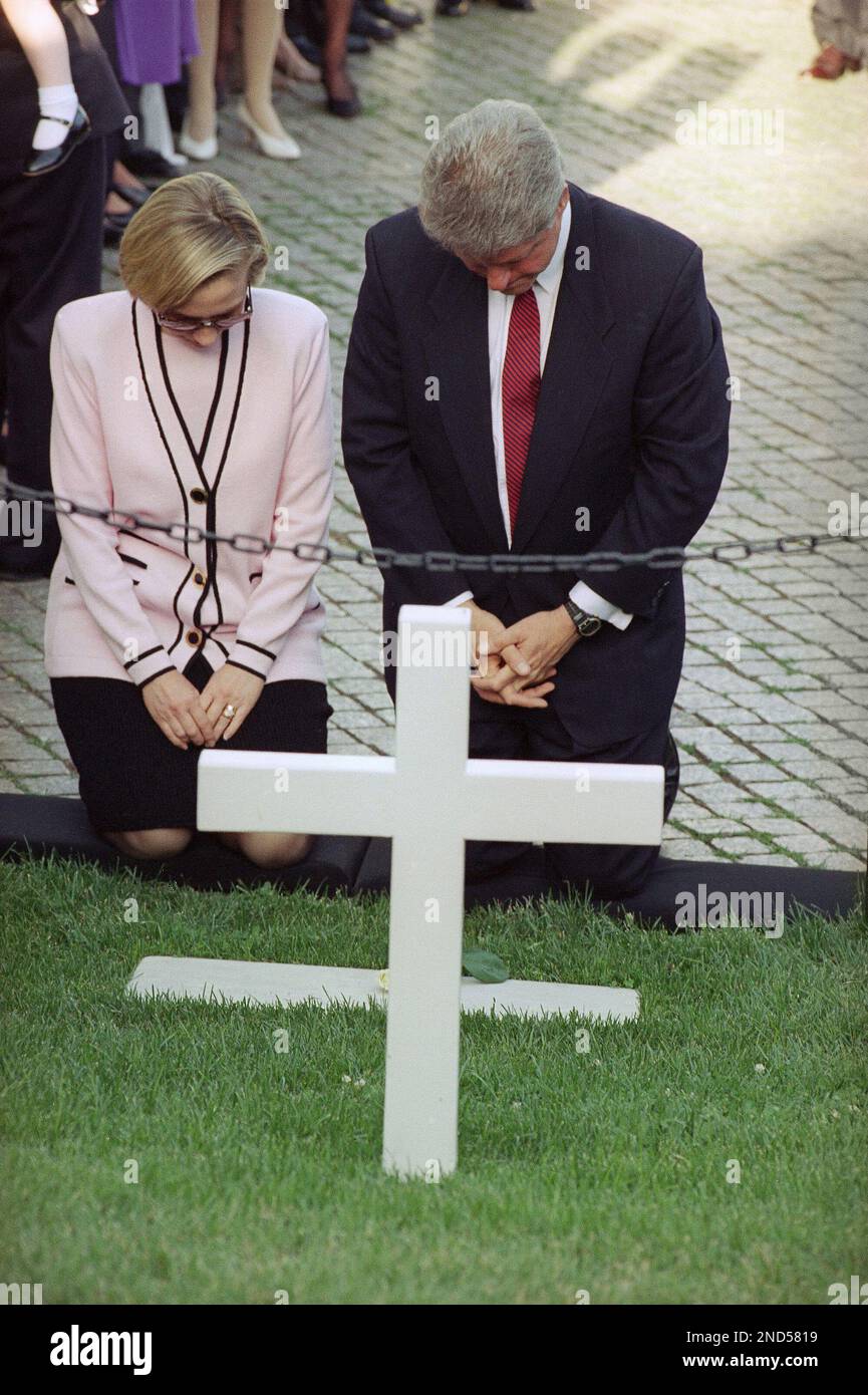 President Bill Clinton and first lady Hillary Rodham Clinton kneel at ...