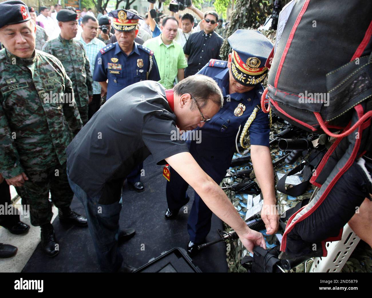 Philippine President Benigno Aquino III, assisted by Police Gen ...