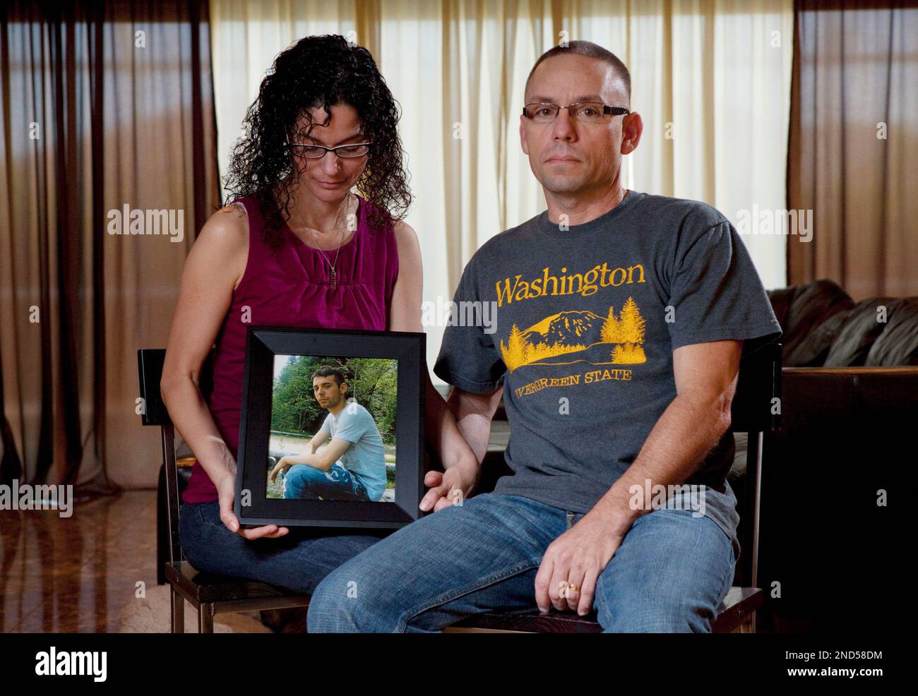 Emma and Christopher Winfield hold a photograph of their son, 22-year ...