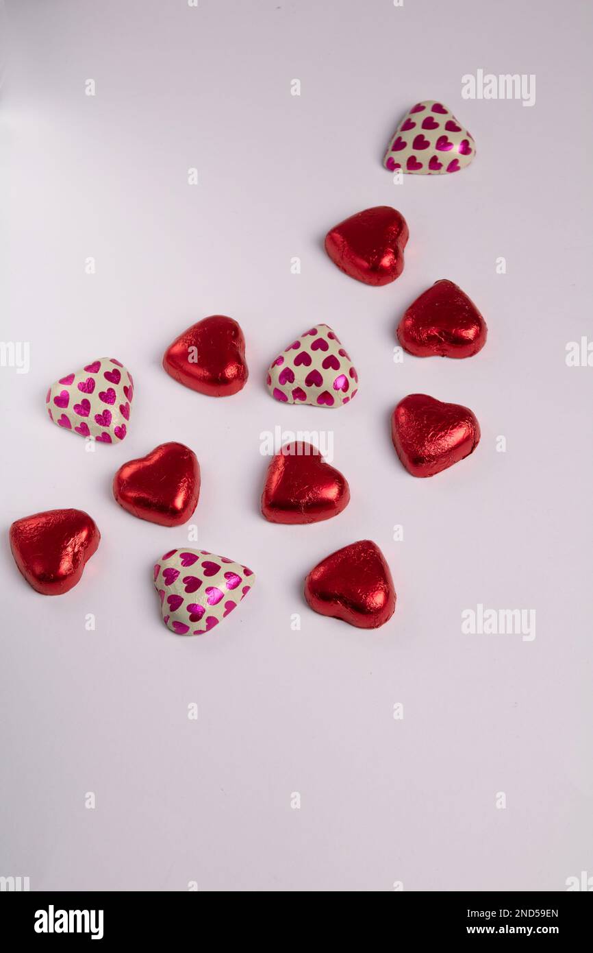 photo a lot of candy in the shape of hearts in a beautiful wrapper on a ...