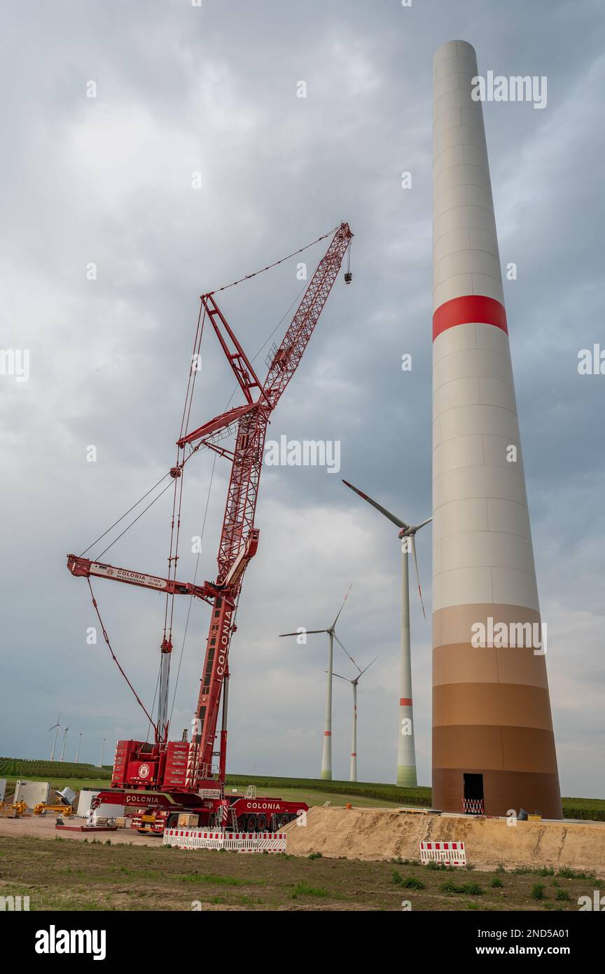 Wind turbine construction site at wind park with crane and completed ...