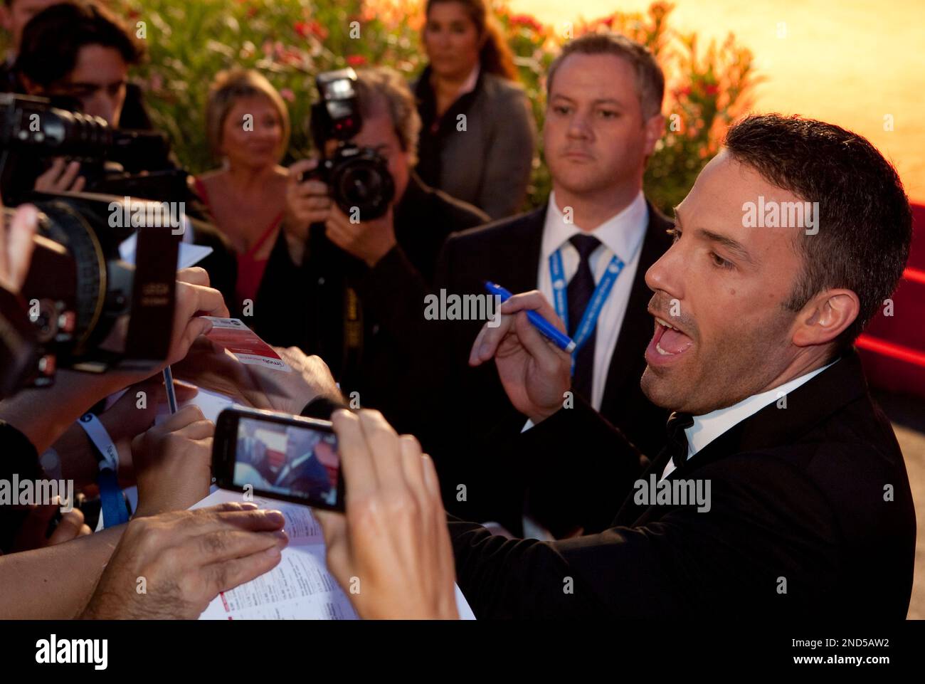 Director Ben Affleck signs autographs as he arrives for the screening ...