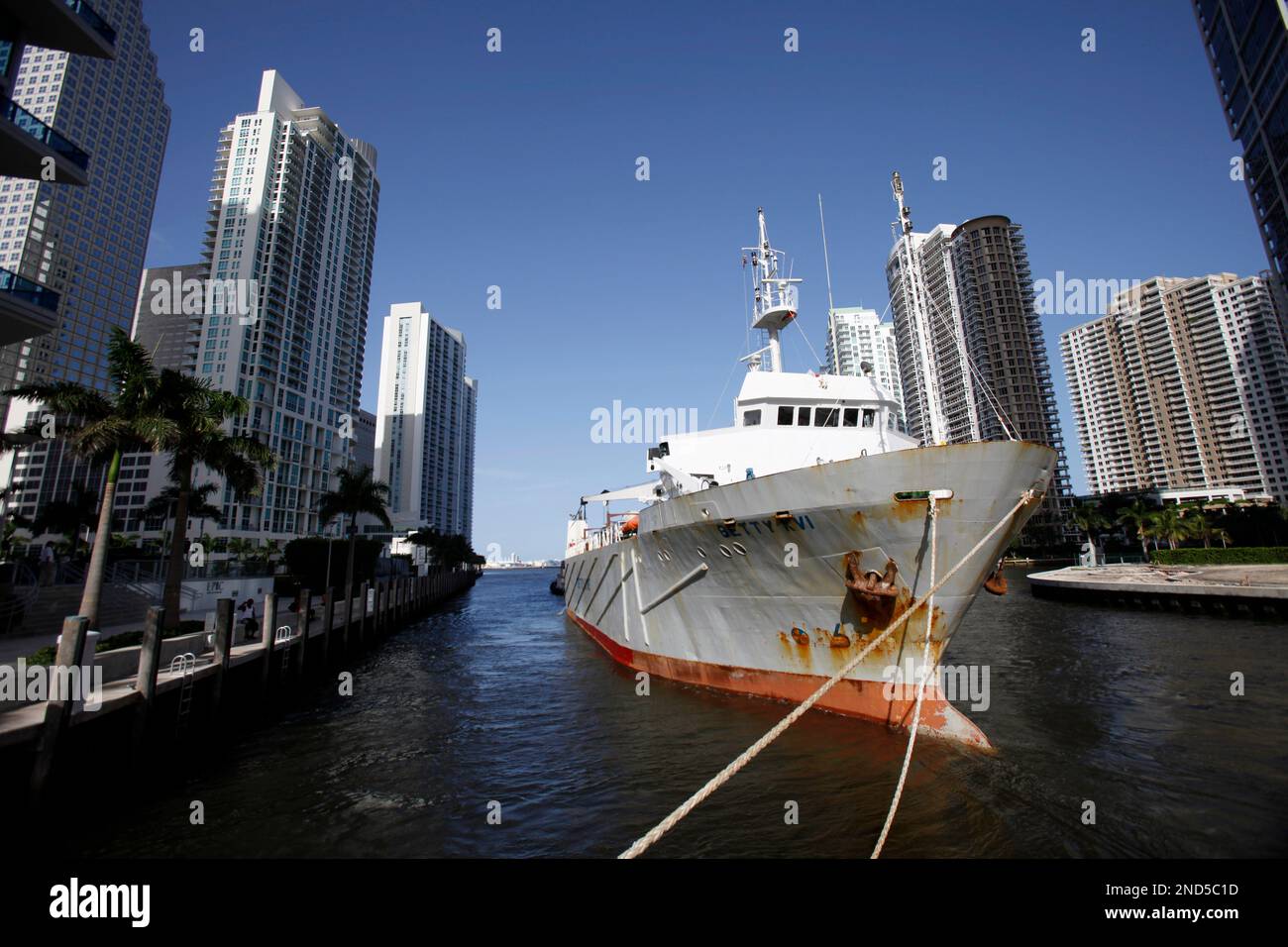 In this photo taken Wednesday, Aug.11, 2010 a freighter is pulled by a tugboat down the Miami ...
