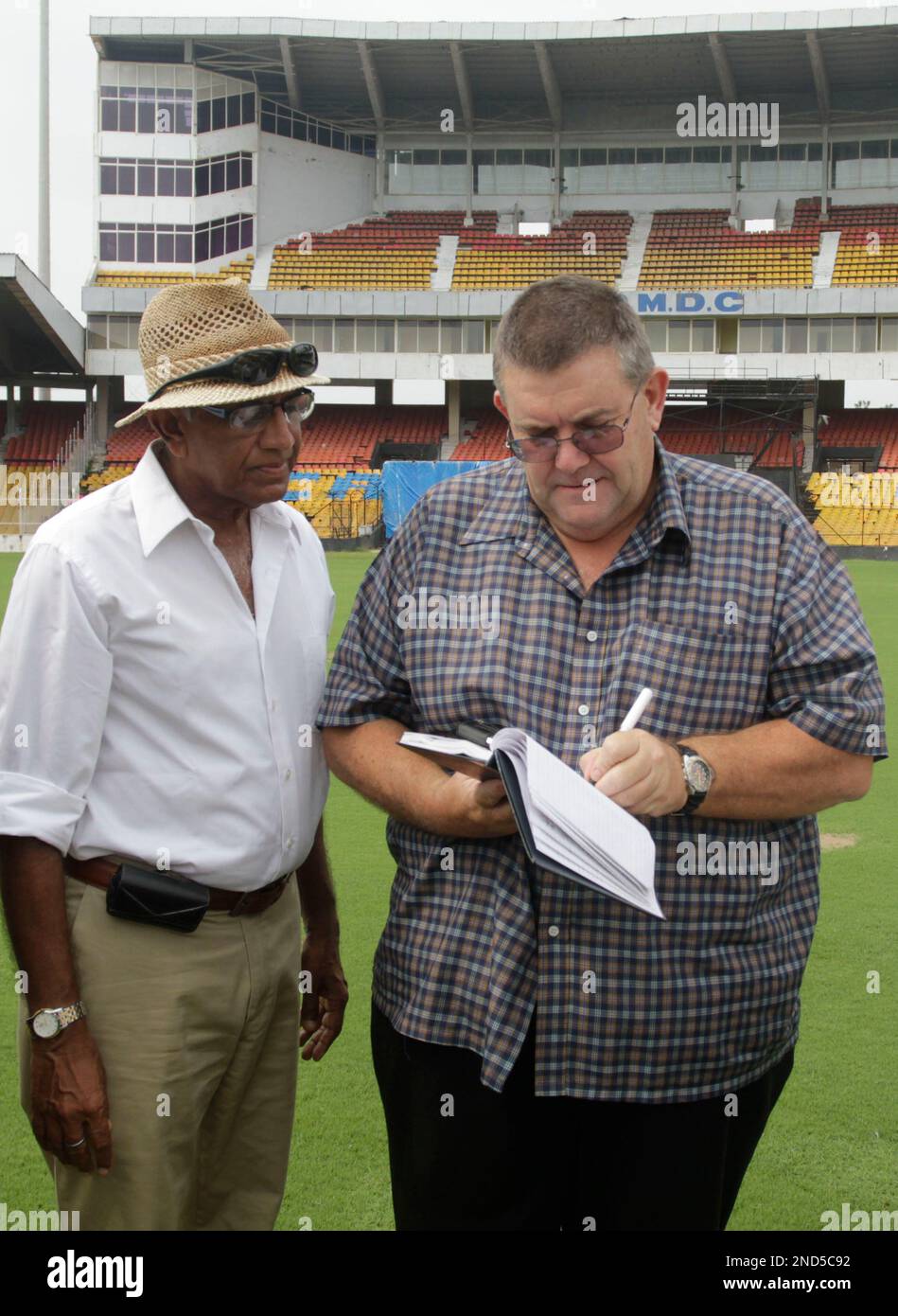 International Cricket Council (ICC) pitch curator Andy Atkinson, right ...