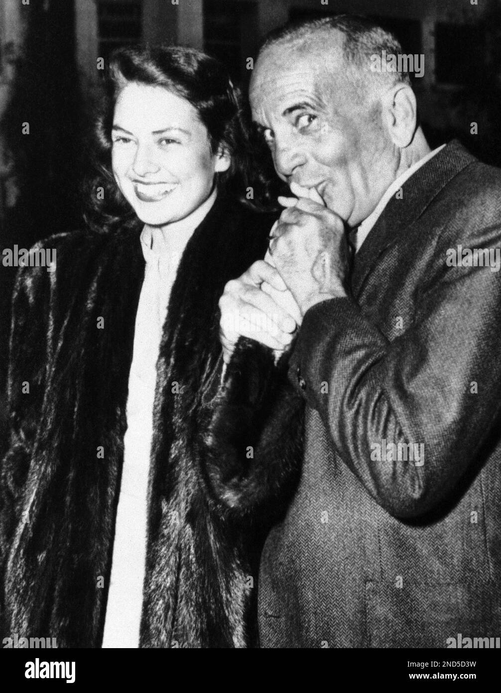 Fifty six year old actor Al Jolson, kisses the hand of his fourth bride ...