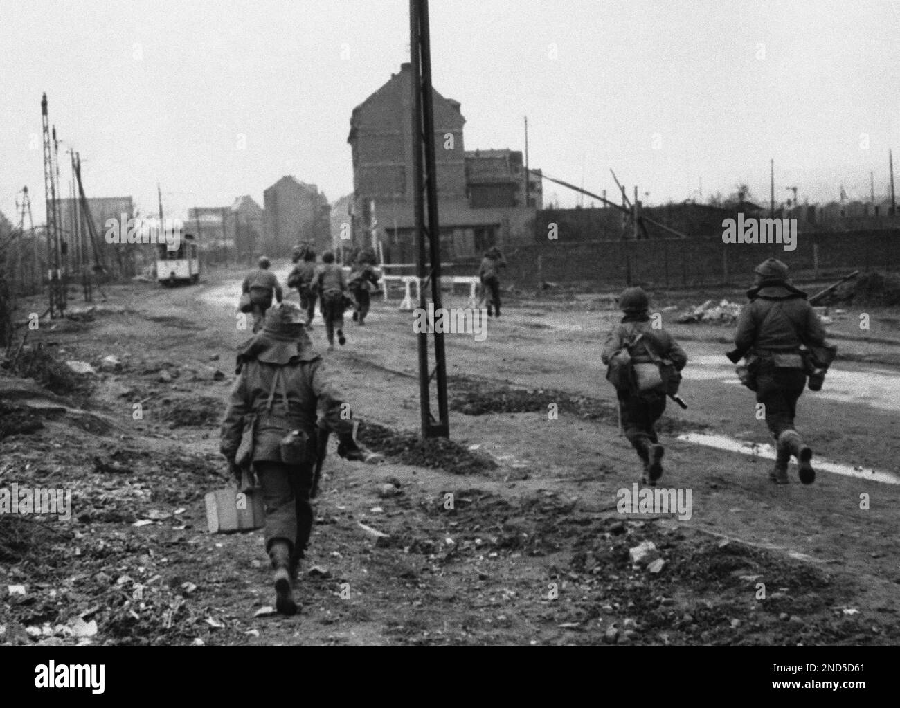 Infantrymen of General Patton’s Third Army sprint across an open space ...