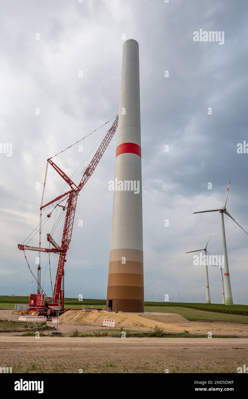 Wind turbine construction site at wind park with crane and completed ...