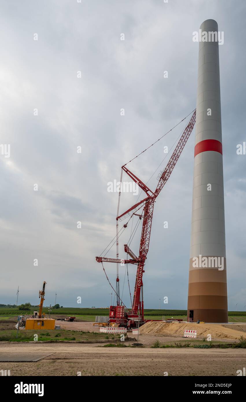 Wind turbine construction site at wind park with crane and completed ...