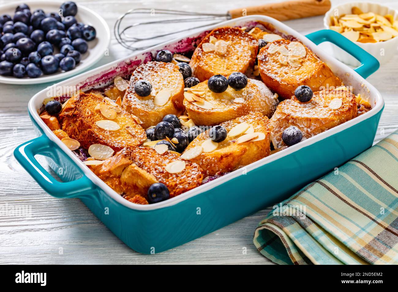 Baked Blueberry Almond Mascarpone French Toast in blue baking dish on ...
