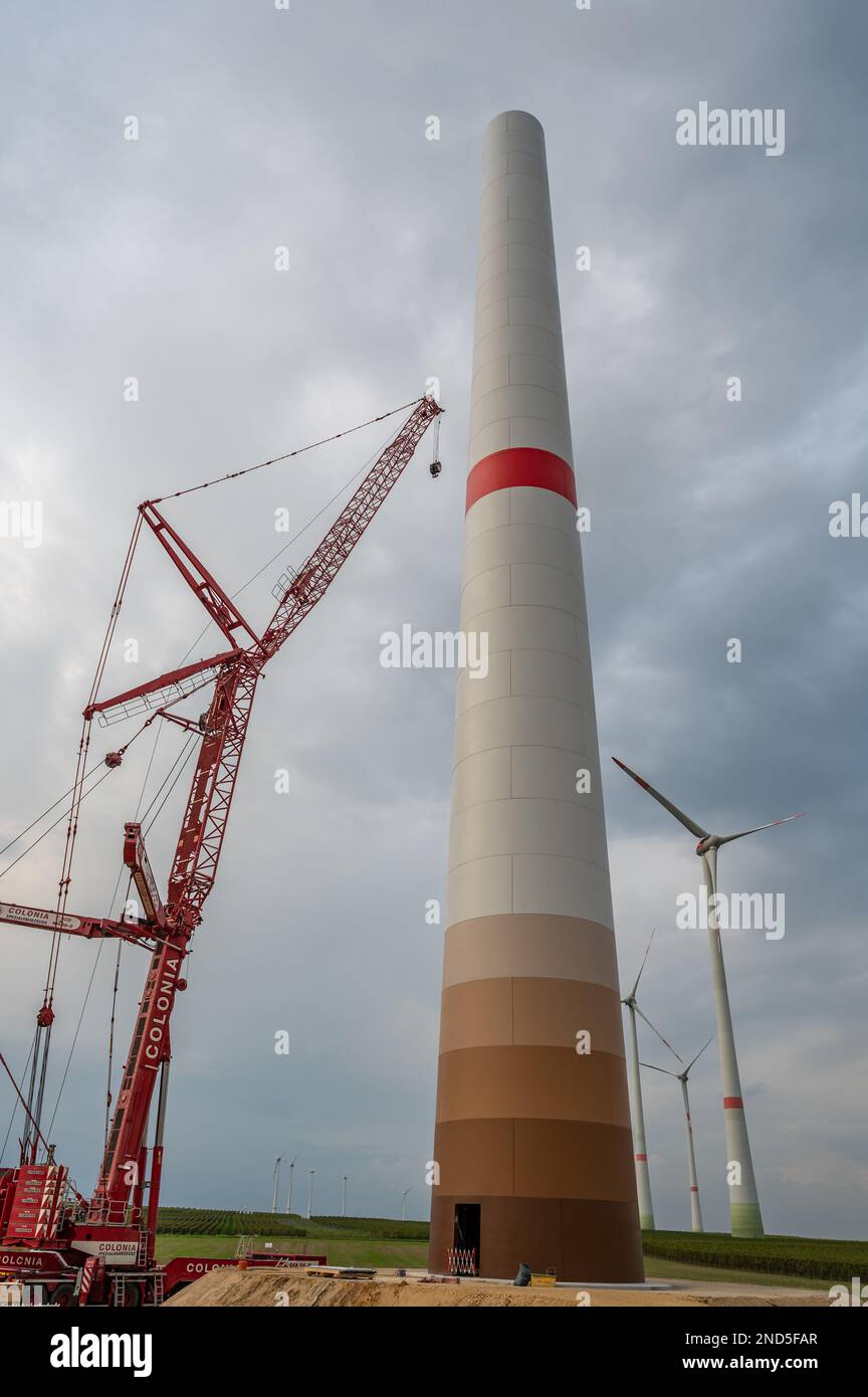 Wind turbine construction site at wind park with crane and completed ...