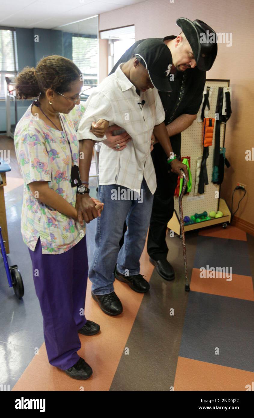 In this photo taken June 22, 2010, Bazelais Suy, walks with the help of ...