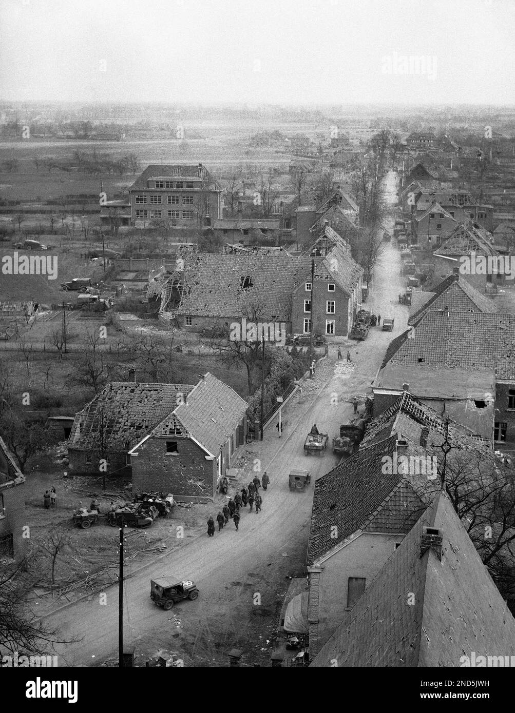 As British armour and troops push on through the main street of ...
