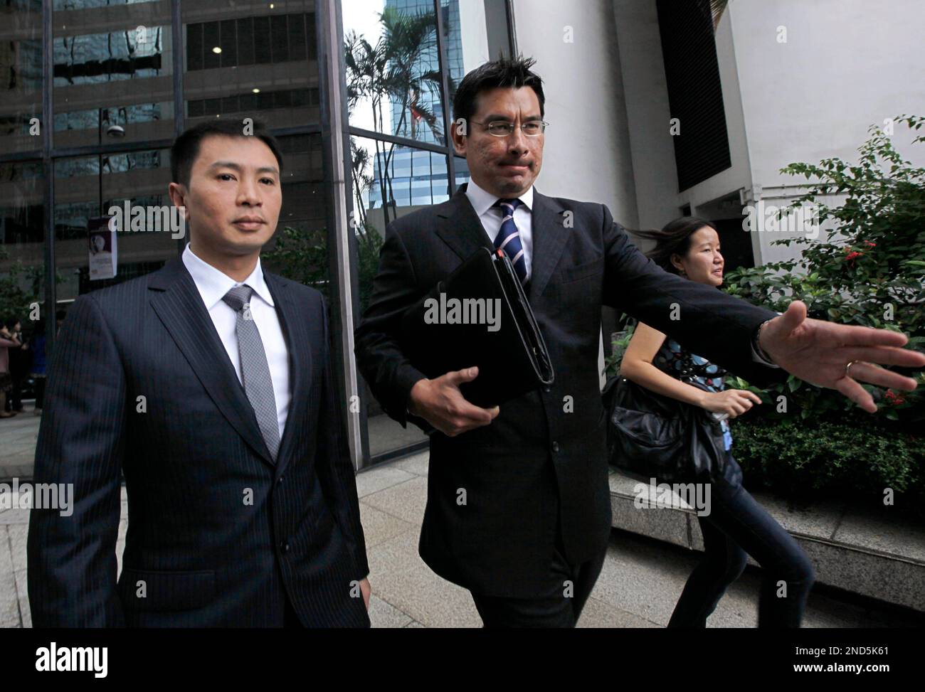 Philippine Rep. Ronald Singson, 41, left, leaves a court in Hong Kong ...
