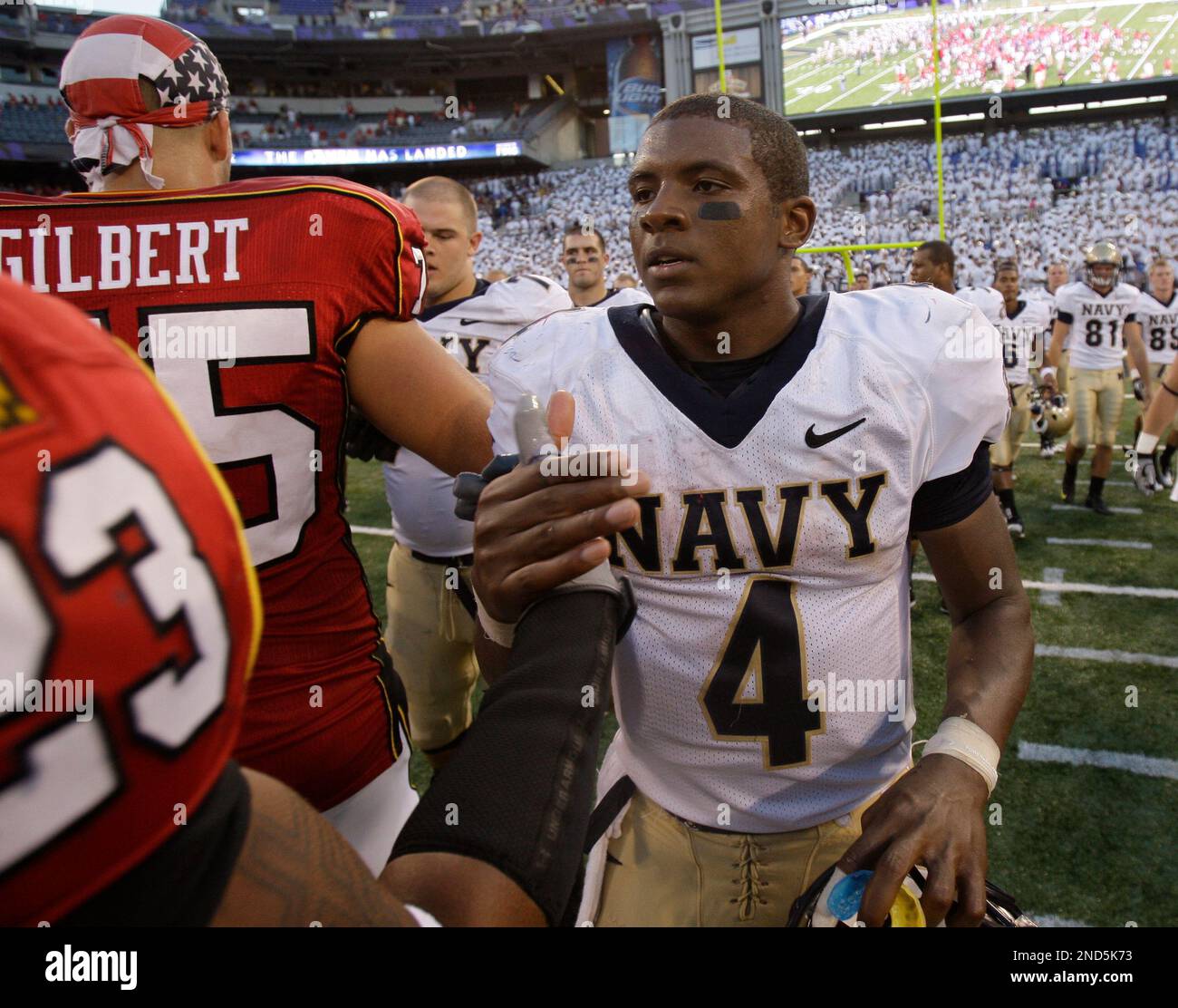 Navy quarterback Ricky Dobbs (4) walks off the field after shaking ...