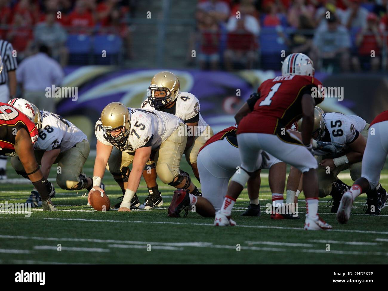 Navy quarterback Ricky Dobbs (4) under center Brady DeMell (75) during ...