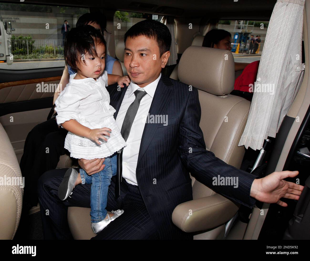 Philippine Rep. Ronald Singson, 41, leaves a court with his daughter ...