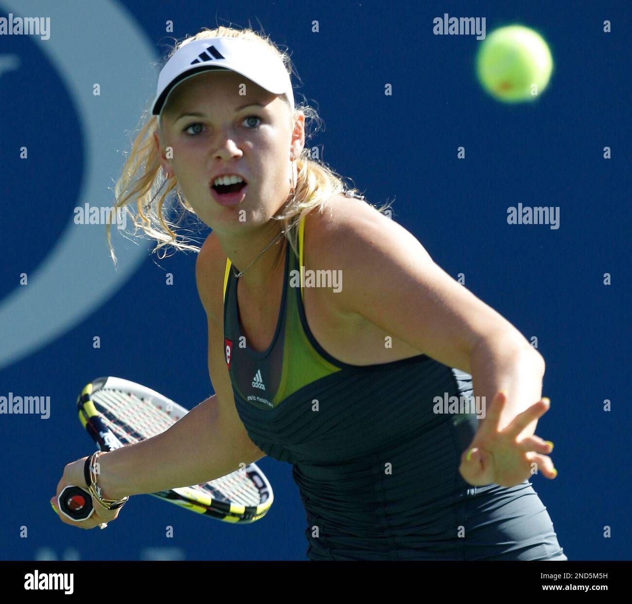 Caroline Wozniacki of Denmark returns the ball to Maria Sharapova of ...