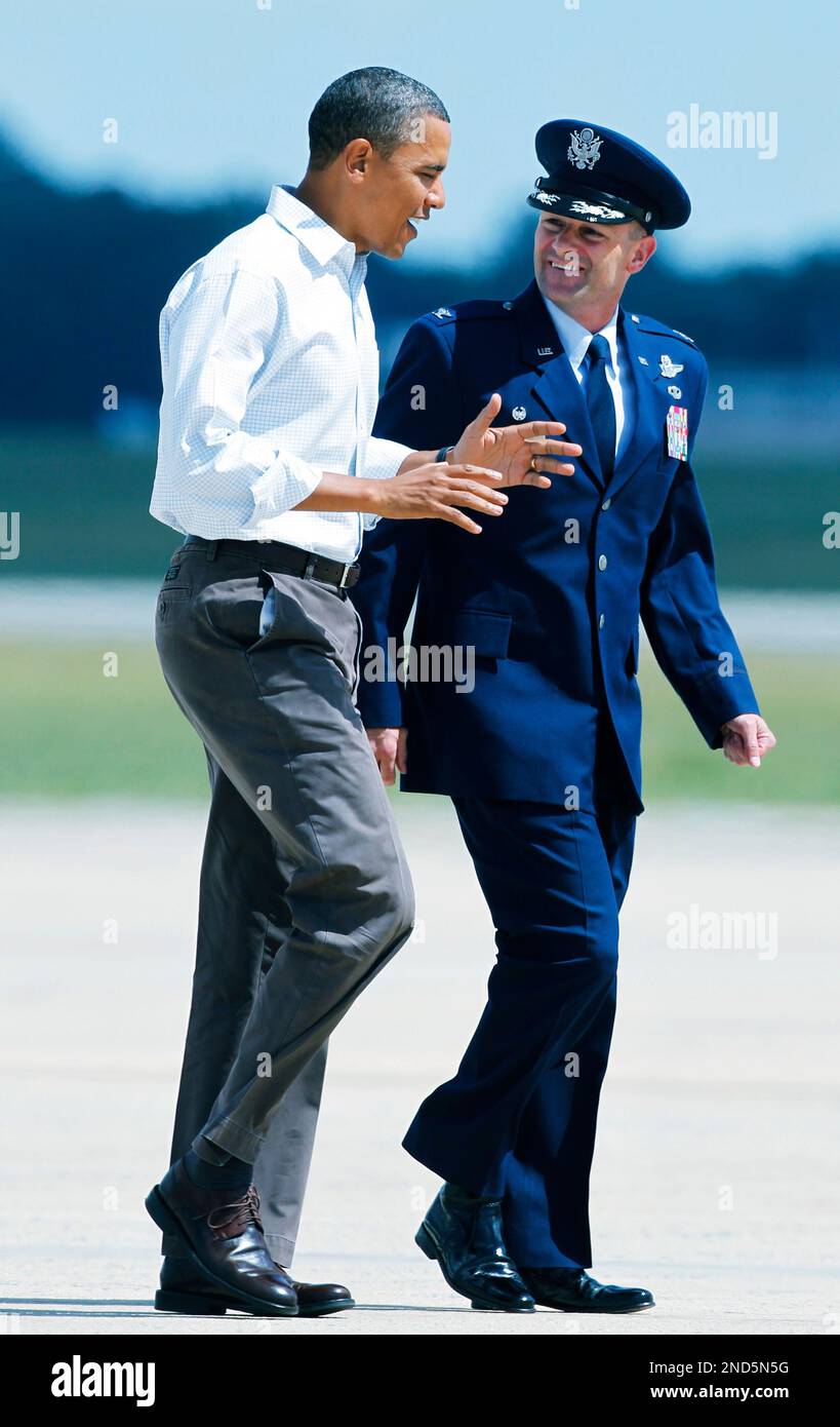 President Barack Obama, left, is escorted Air Force Col. Kenneth Rizer ...