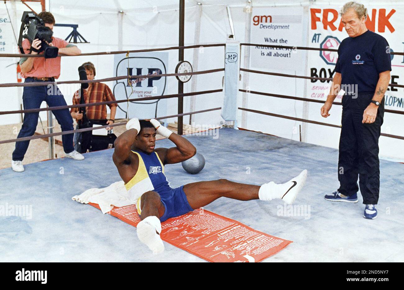 British Heavyweight champion Frank Bruno exercises as trainer George ...