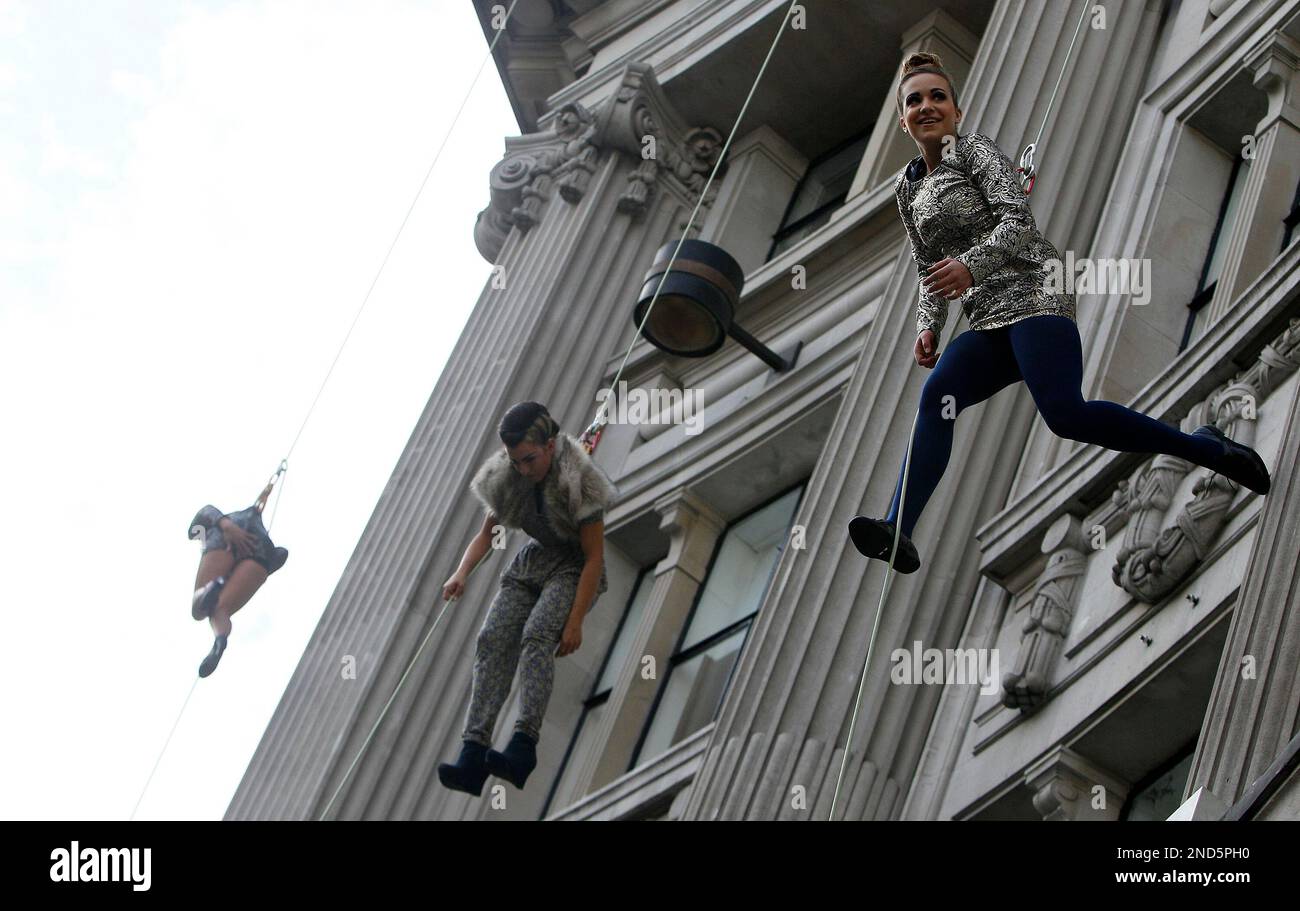 Female abseilers model the latest high street fashion by abseiling down ...