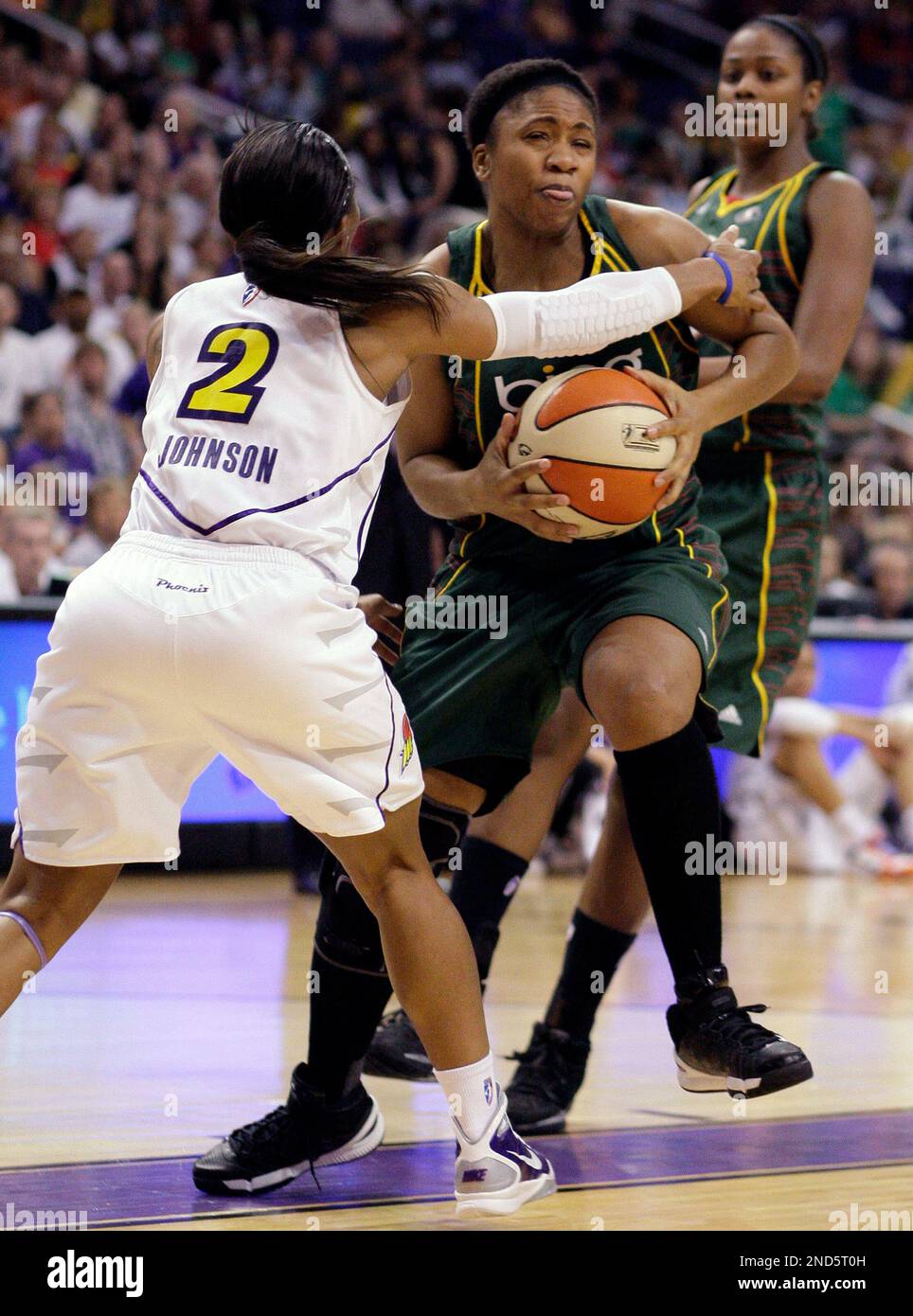 Seattle Storm guard Tanisha Wright, center, is fouled by Phoenix Mercury guard Temeka Johnson ...