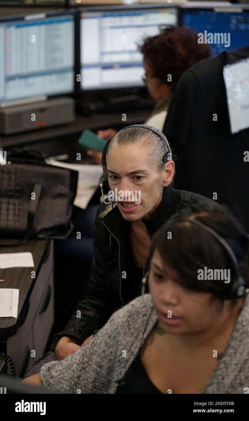 Dispatcher Joan Vallarino, (center) works with dispatch trainee Kim ...