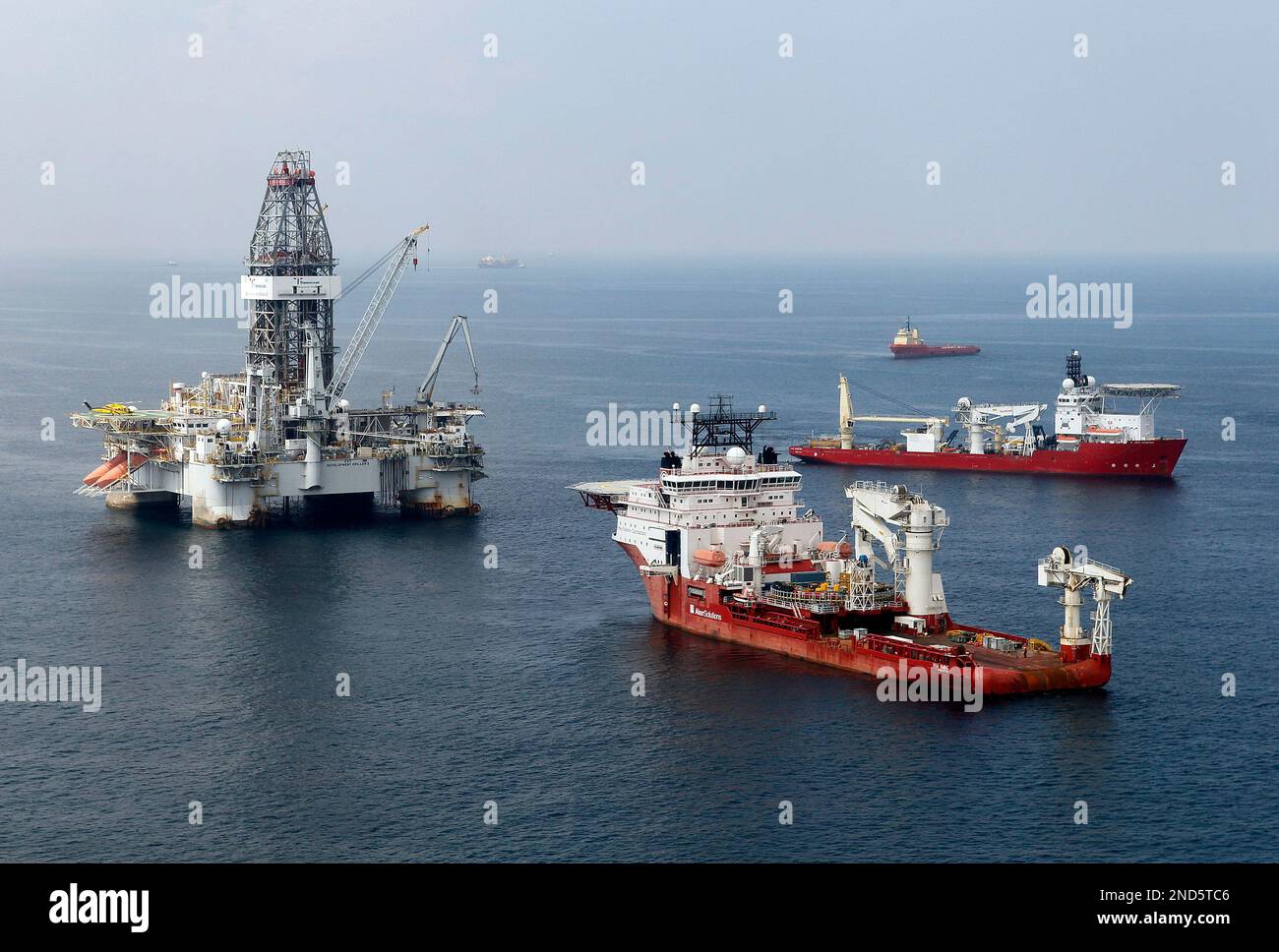 The Transocean Development Driller II, left, which is assisting in the ...