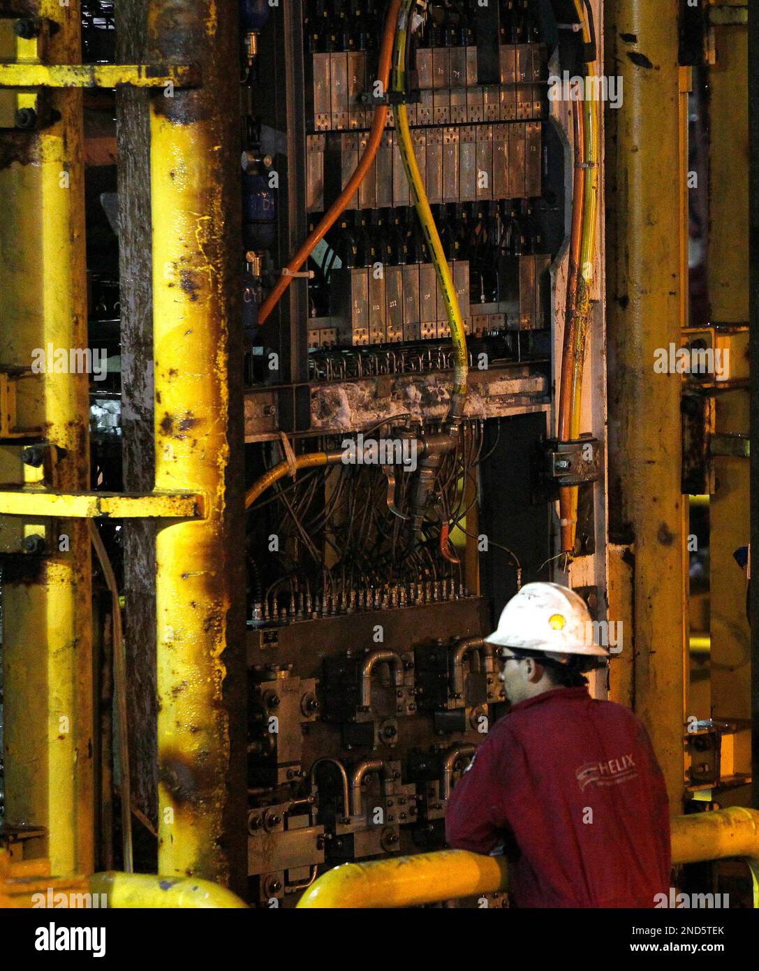 A worker watches as the Deepwater Horizon blowout preventer stack is ...