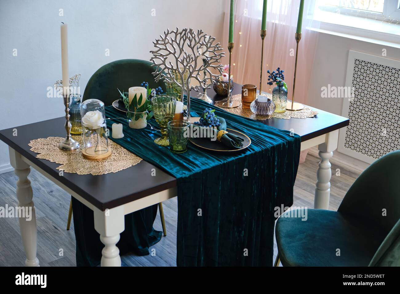 The luxury served table indoors in green colors. Dark wooden table ...
