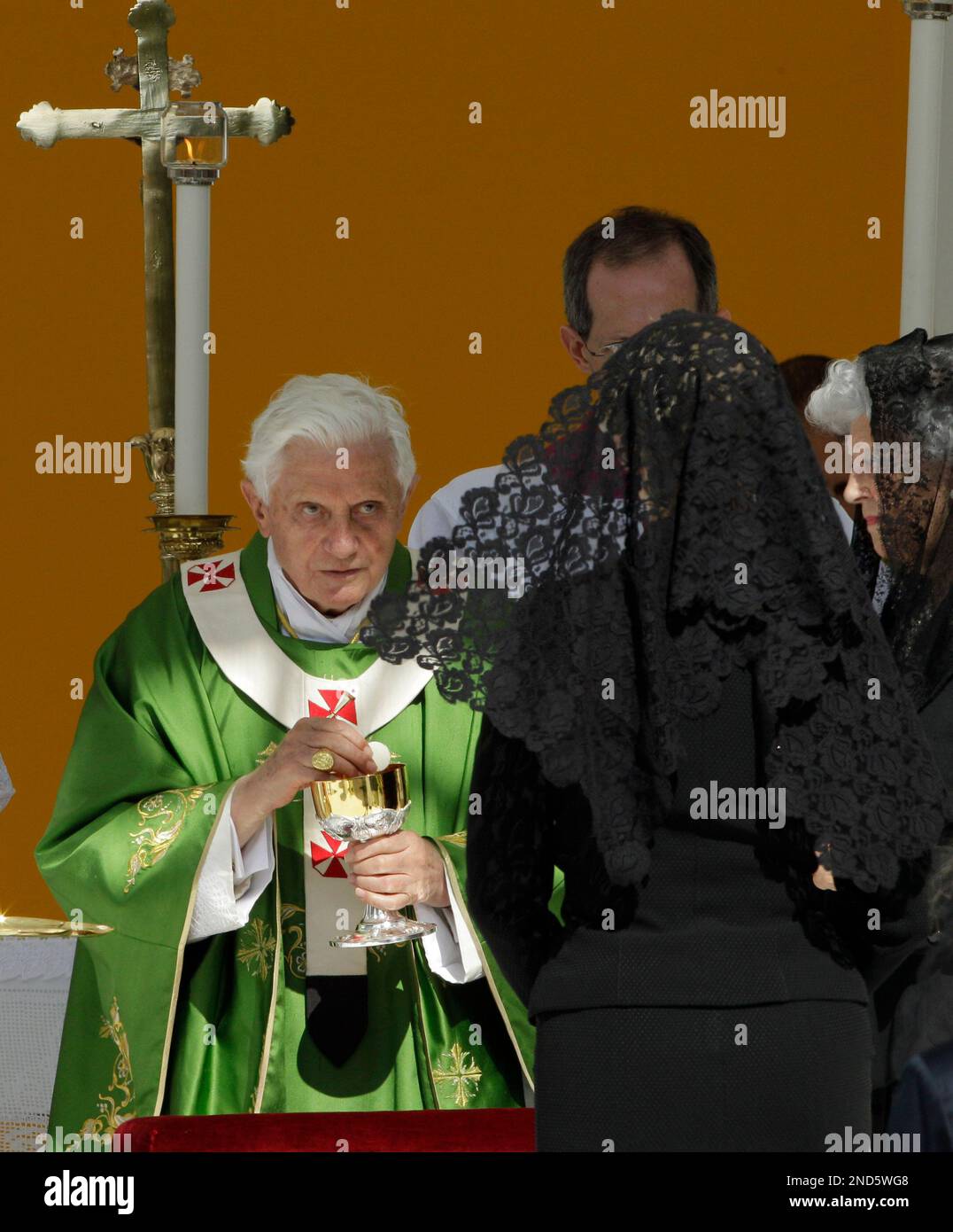 Pope Benedict XVI gives the holy communion during a mass on the ...