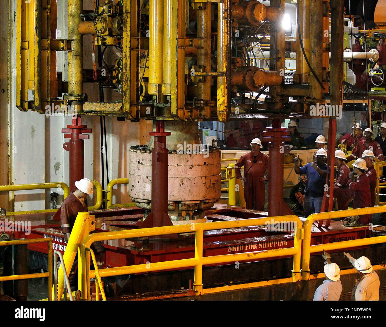 Workers watch as the Deepwater Horizon blowout preventer stack is ...