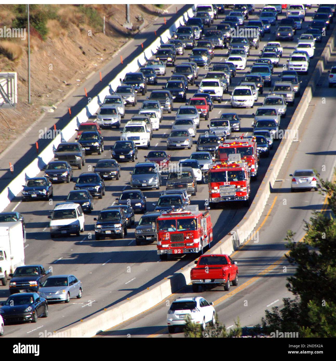 Three of 50 LAFD fire engines fight through heavy traffic to get to the ...