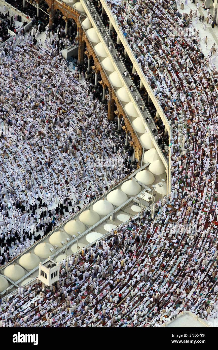 Tens of thousands of Muslim pilgrims moving around the Kaaba, the black ...