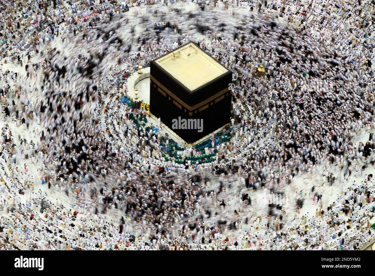 Tens of thousands of Muslim pilgrims moving around the Kaaba, the black ...