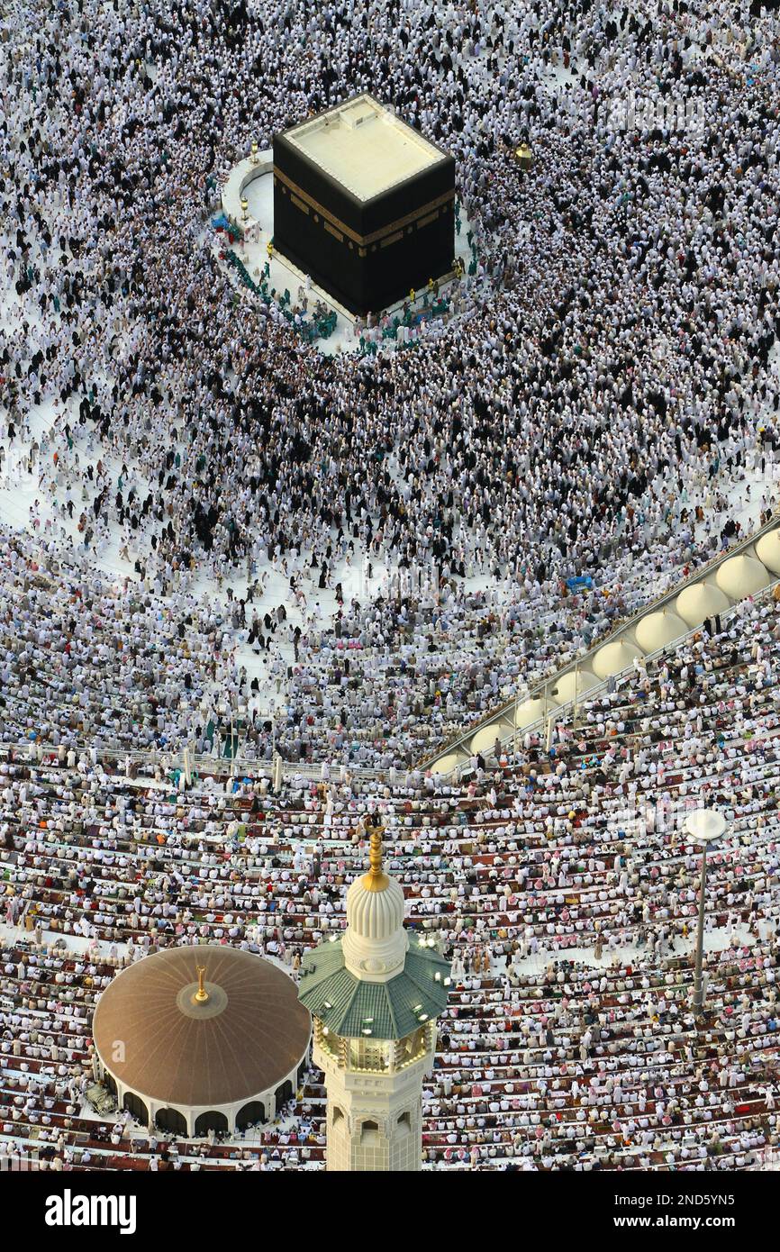 Tens of thousands of Muslim pilgrims moving around the Kaaba, the black ...