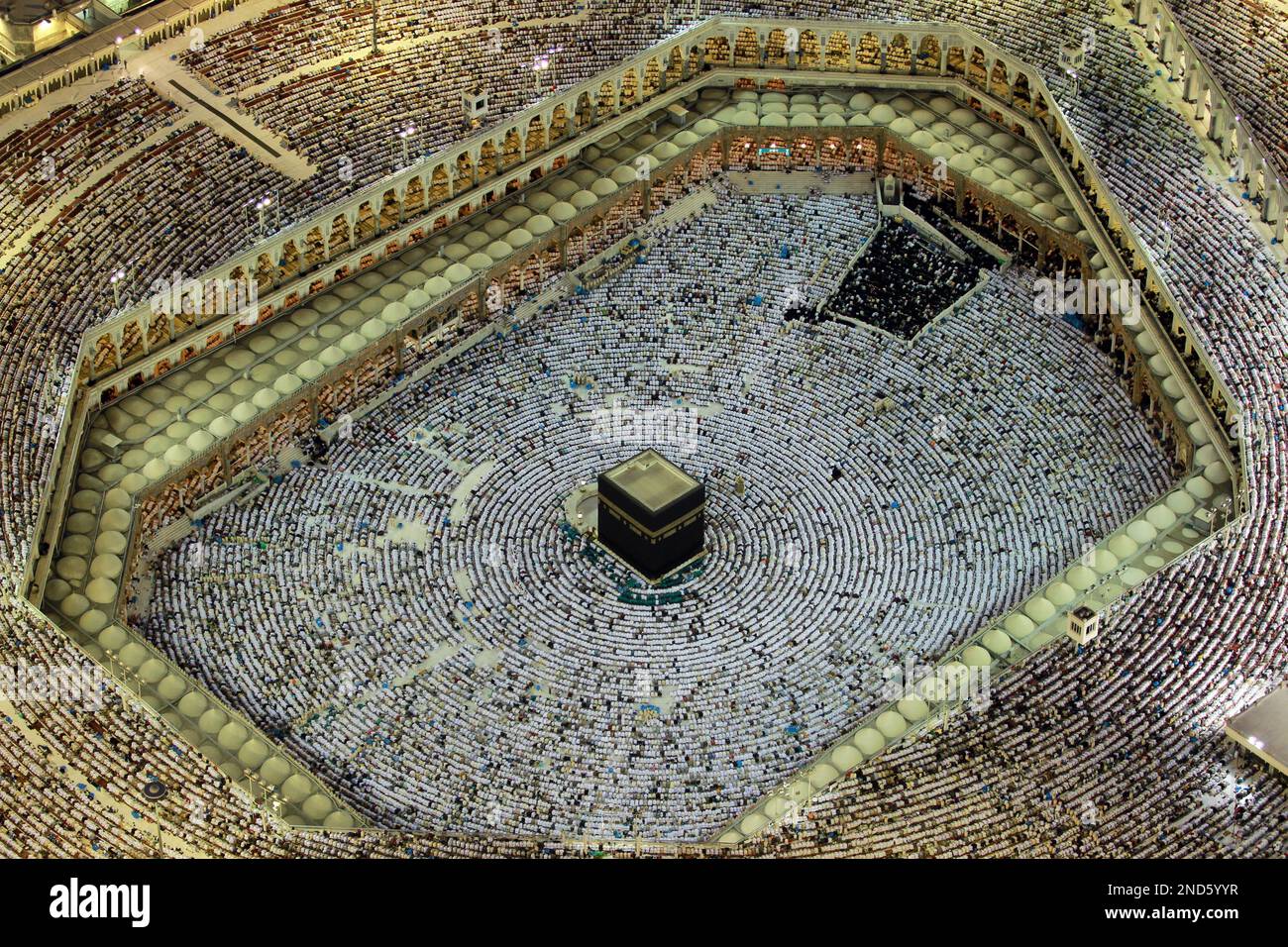 Tens of thousands of Muslim pilgrims moving around the Kaaba, the black ...
