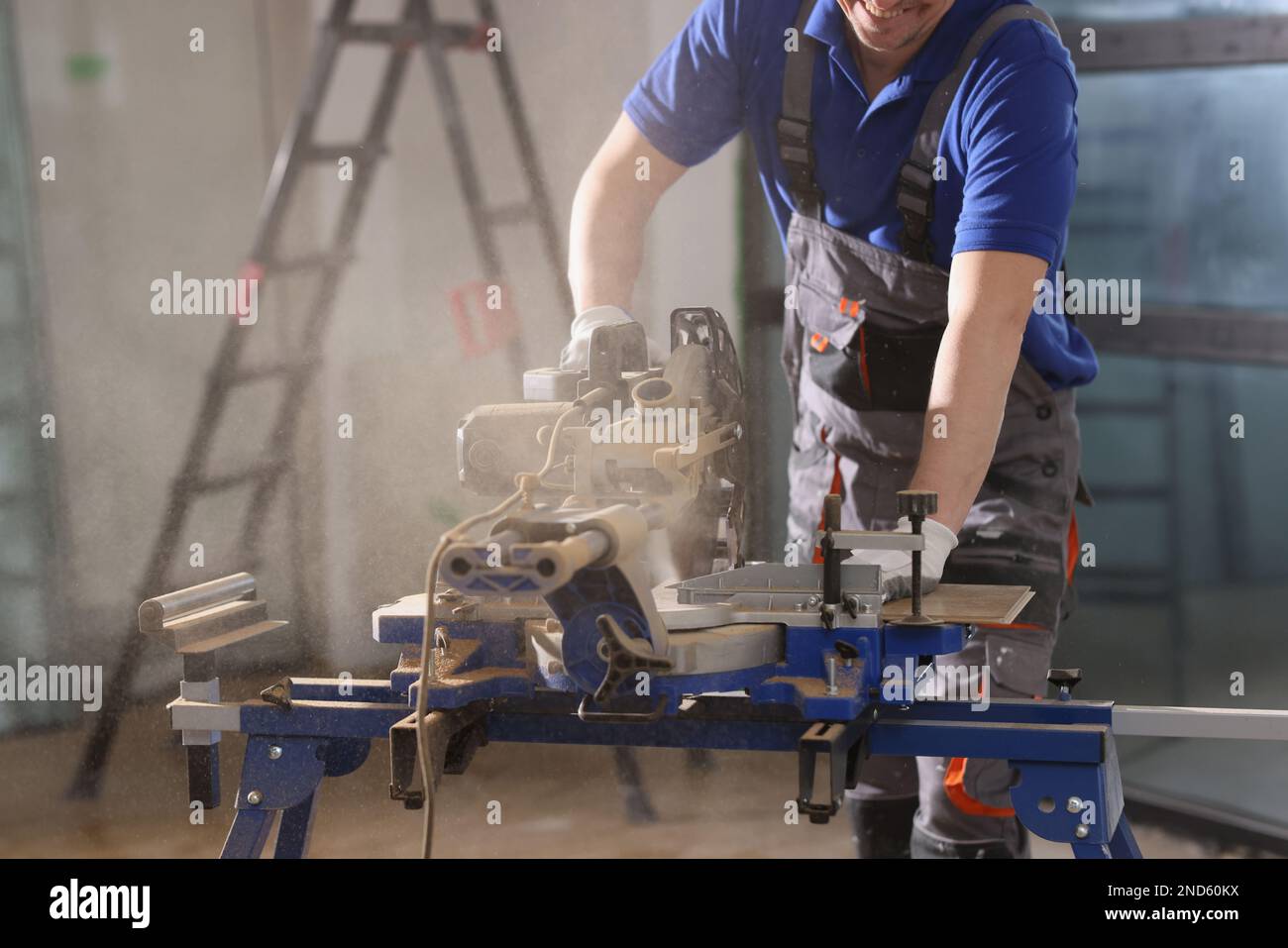 A happy worker works behind a cutting machine, close-up Stock Photo - Alamy