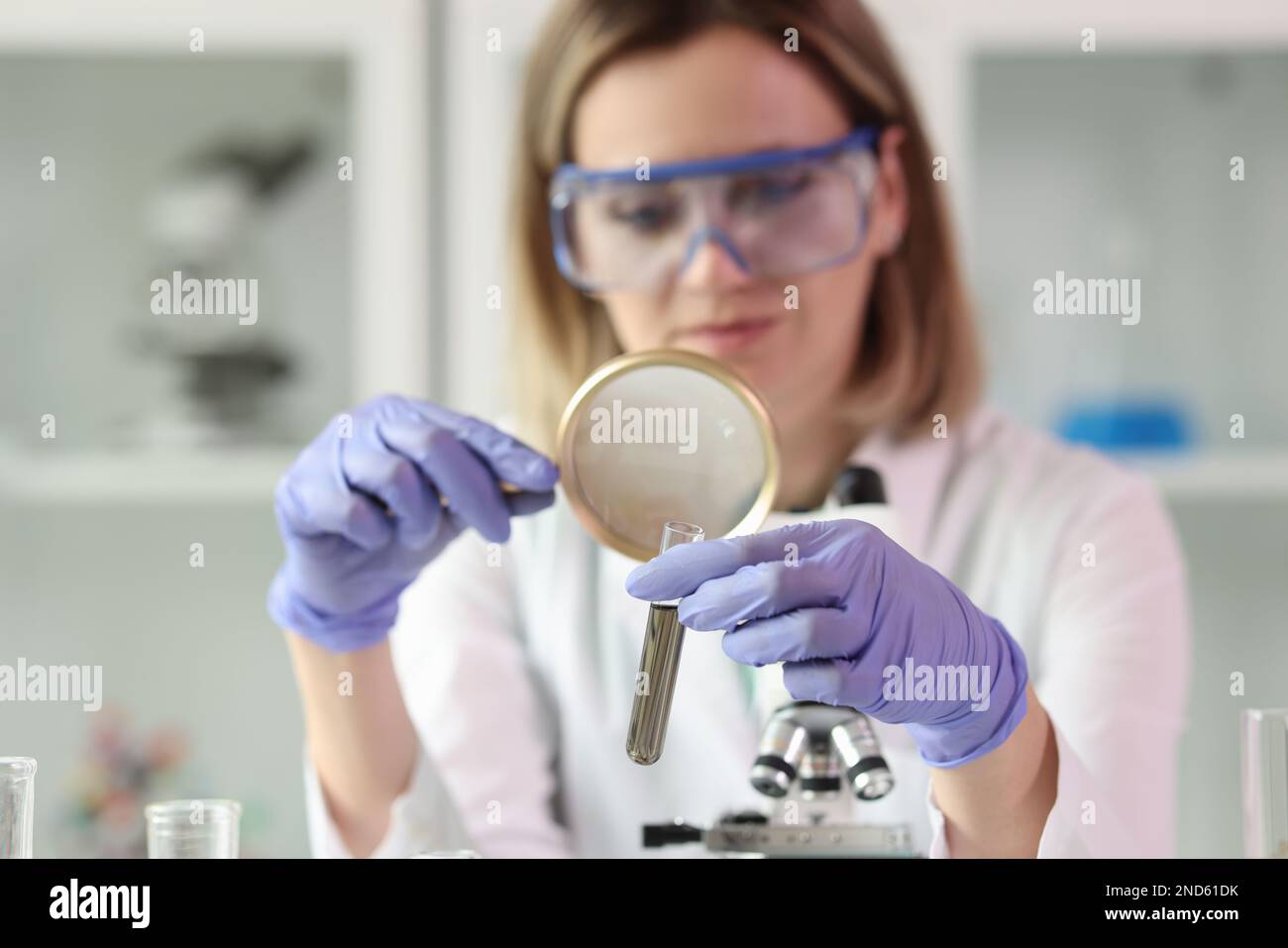 Female scientist magnifying glass tube hi-res stock photography and ...