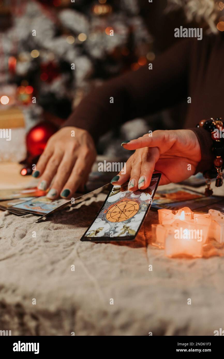 woman lays out magic cards on a table by candlelight. divination ...
